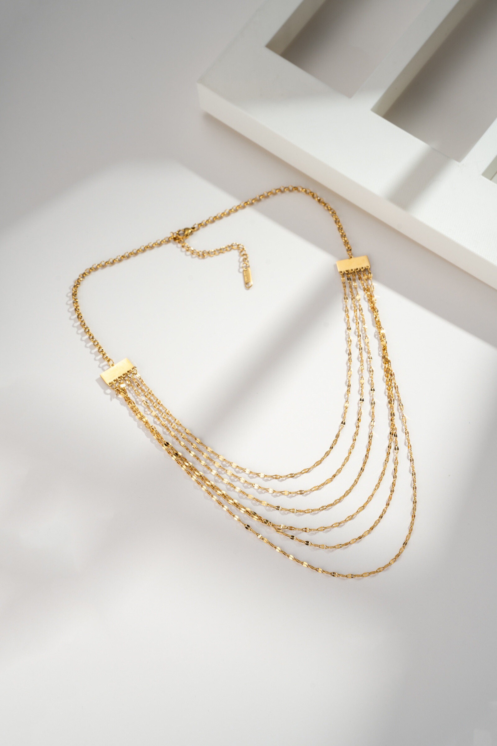 Golden multi-chain necklace with an elegant cascade – light, fluidity ...