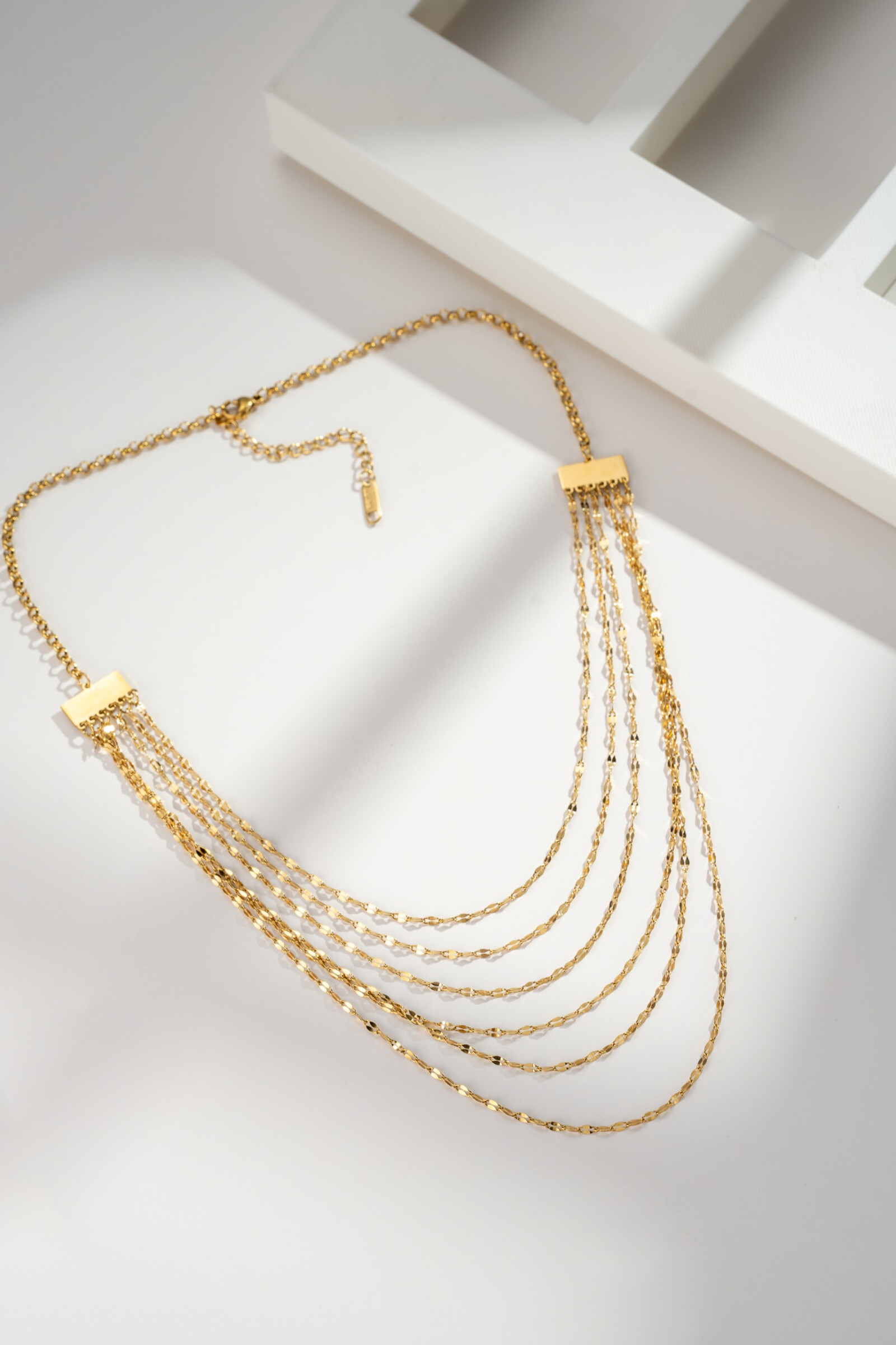 Golden multi-chain necklace with an elegant cascade – light, fluidity ...